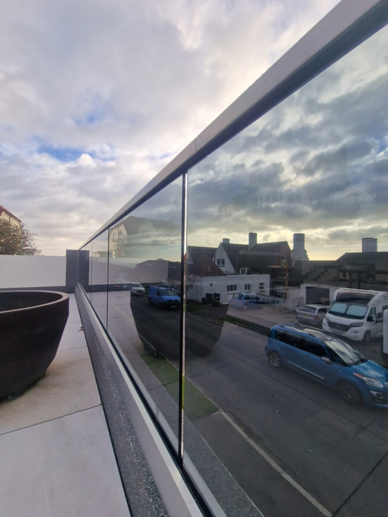 A frameless glass balustrade with grey smoke tint glass in Brighton ...